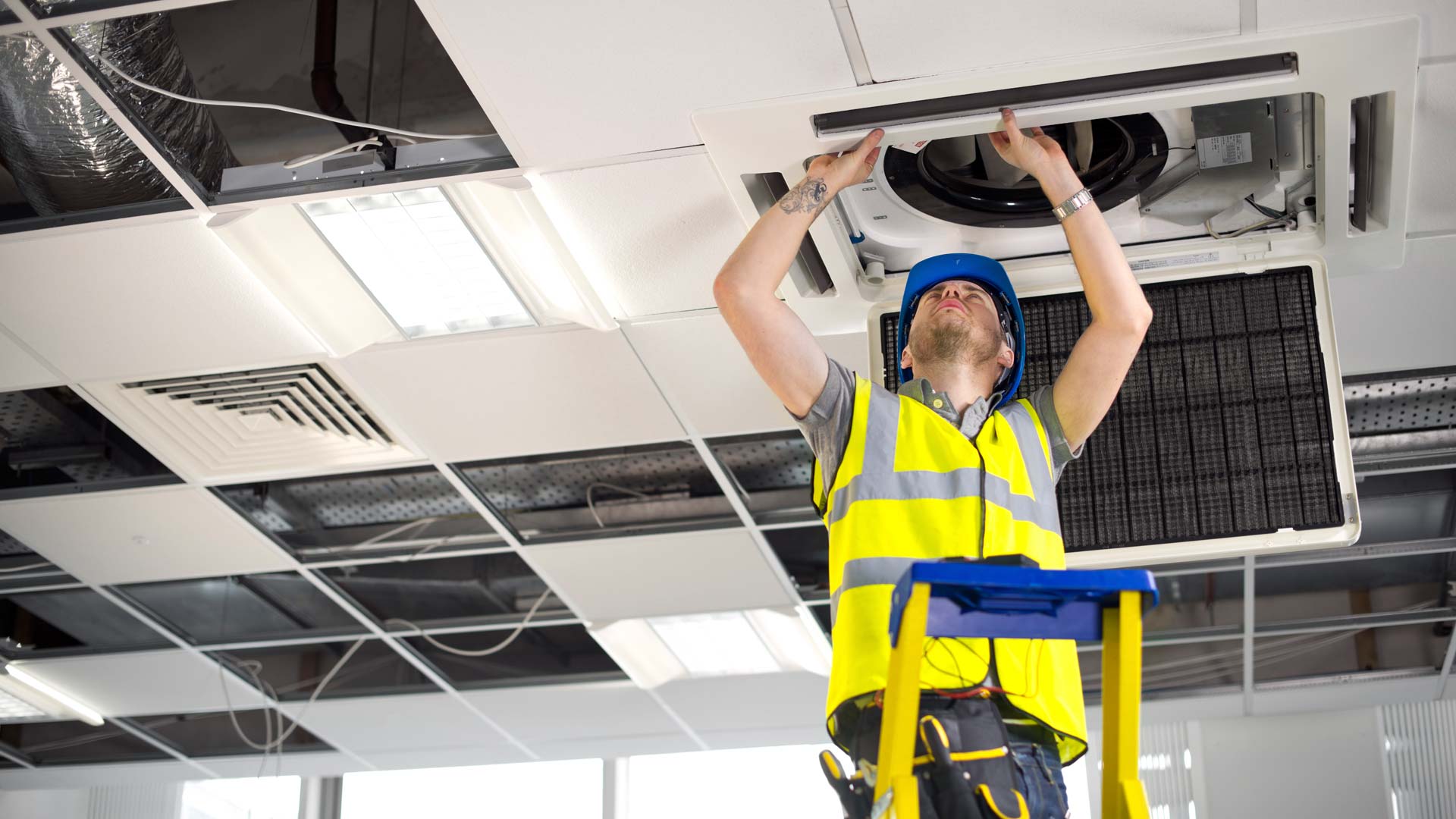 man-inspecting-ceiling - Northants Scaffold Ltd